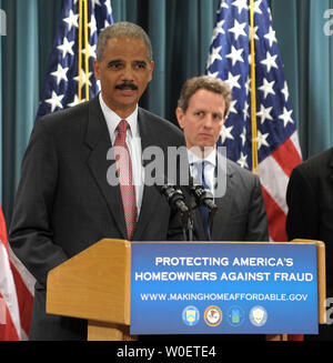 With Attorney General Eric Holder looking on, President Barack Obama ...