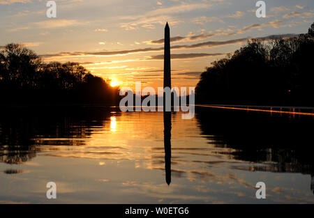 The sun rises over the Washington Monument Wednesday, July 1, 2026, in ...