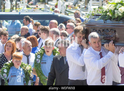 The remains of the late rally driver Manus "Mandy" Kelly are carried ...