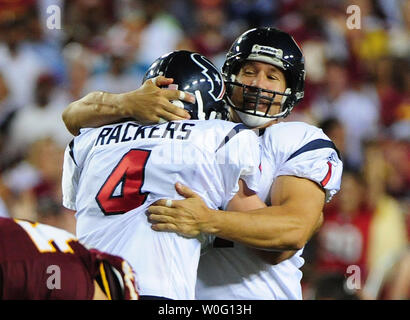 Houston Texans holder Matt Turk (1) and kicker Neil Rackers (4) follows ...