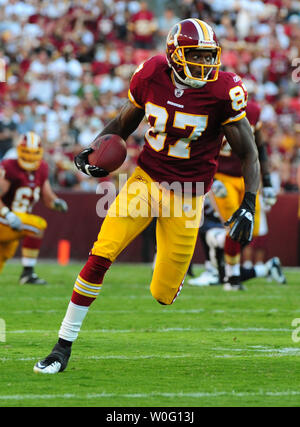 Washington Redskins running back Larry Johnson, left, is stopped for a ...