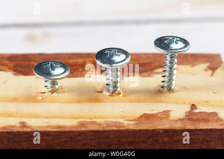 screw screwed into a wooden bar Stock Photo - Alamy