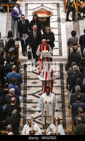 Bishop Gene Robinson carries the remains of Matthew Shepard, followed ...