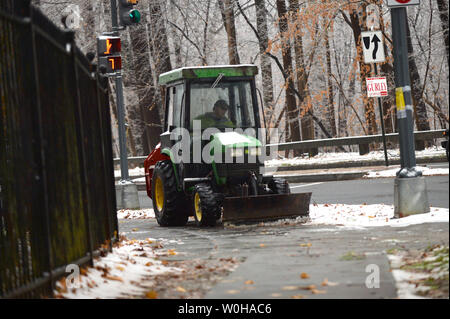 A worker cleans off snow in front of the Prague Castle after a heavy ...