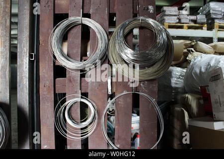 some coils of fechral thick refractory wire hangs in a warehouse of ...