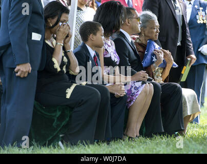 Nola Whitfield, wife of 2nd Lt. Malvin G. Whitfield, hugs the U.S. flag ...