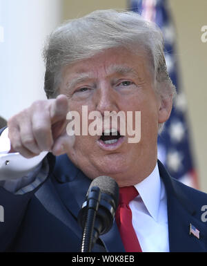 President Donald Trump points to a reporter to ask a question during a ...