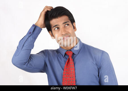 Young Indian Confused Man Scratching His Chin on white background Stock ...