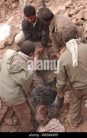 Rescue workers recover bodies from under the rubble after a Russian ...