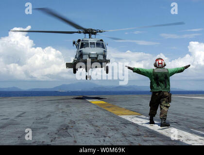 US Navy A Landing Signals Enlisted (LSE) direct an SH-60B Seahawk ...