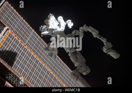 In the grasp of the station's robotic Canadarm2, Dextre (C), also known as the Special Purpose ...