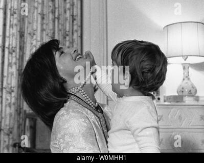 John F. Kennedy, Jr., plays with his dog, Shannon, at Brambletyde house ...