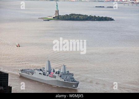 Crew members man the rails aboard the nuclear-powered aircraft carrier ...