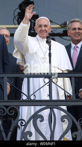 Pope Francis speaks to the crowd in St. Peter's Square from the window ...