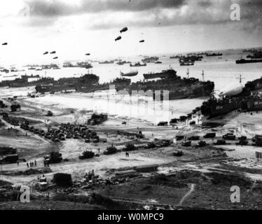 Landing ships putting cargo ashore on Omaha Beach, at low tide during ...