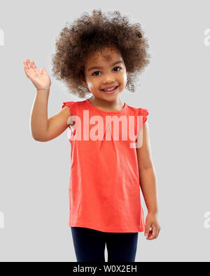 African happy kid waving his hand and smiling during video call on his ...
