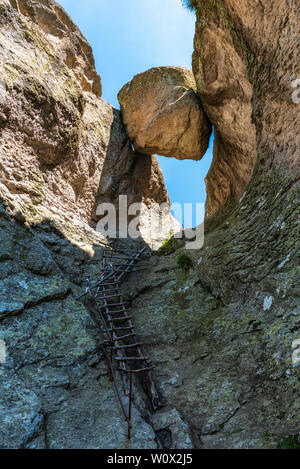 Natural rock formation consisting of big boulder stuck between two ...