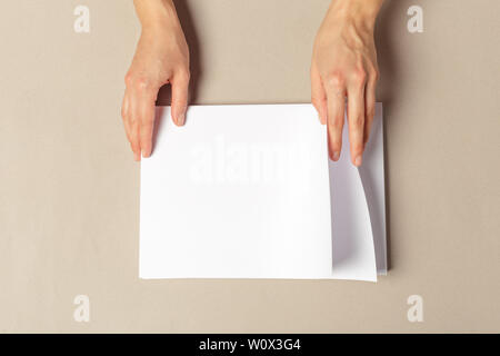 Hand holding papers a4 size Stock Photo - Alamy