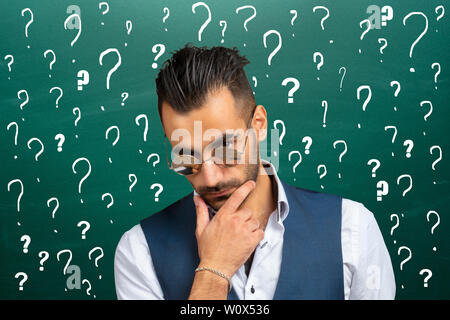 Puzzled thoughtful young man curiously looking at camera Stock Photo ...