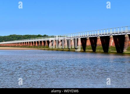 Arnside rail railway viaduct across the River Kent Estuary at village ...