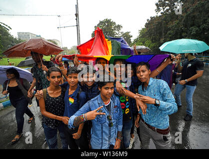 LGBT Community members seen walking with a large LGBT flag under heavy ...