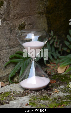 LOOPER An hourglass sits on a ledge to an opening of a old and historic ...
