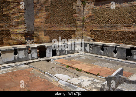 Ancient Roman public latrines at Ostia Antica near Rome Stock Photo - Alamy