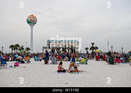 Beachgoers sit under an umbrella on the beach in Kühloungsborn, Germany ...
