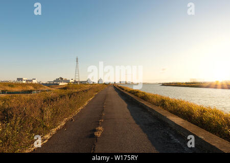 Road along a river at sunset in autumn Stock Photo - Alamy