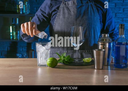 Barkeeper preparing Blue Lagoon cocktail at table in bar Stock Photo ...