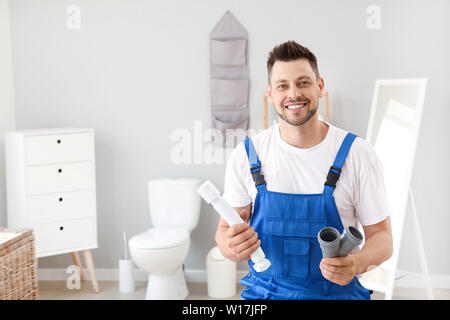 Portrait of handsome plumber in restroom Stock Photo - Alamy