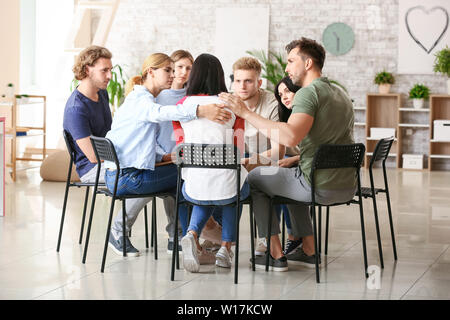People calming woman at group therapy session Stock Photo - Alamy