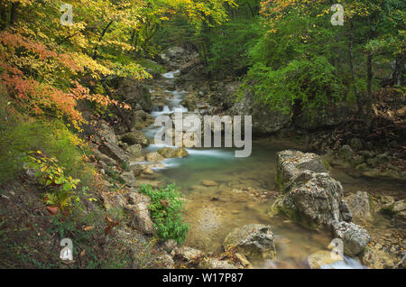 Autumn waterfall and rill flow. Nature composition Stock Photo - Alamy