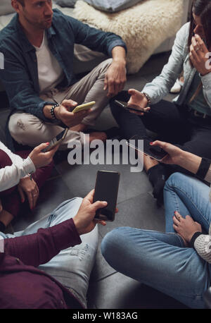 Group of young people using cellphones inside coffee shop. millennial ...