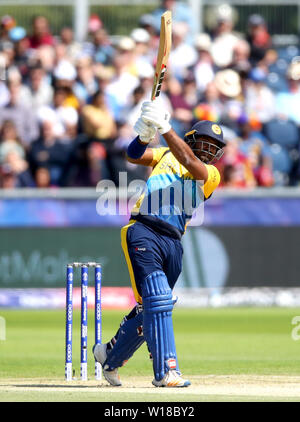 Sri Lanka's Kusal Perera bats as New Zealand's Mitch Hay looks on ...
