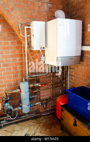 Heating boiler with pipes installed in residential house Stock Photo ...
