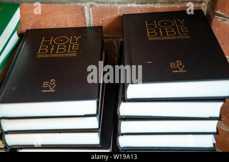 Stacks of bibles on a table in a church Stock Photo - Alamy