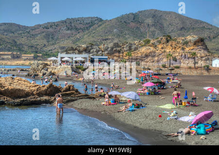 HDR image of the Black sand beach at Portman in Murcia, Spain Stock ...