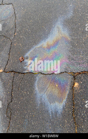 Spilled oil on the asphalt road background Stock Photo - Alamy