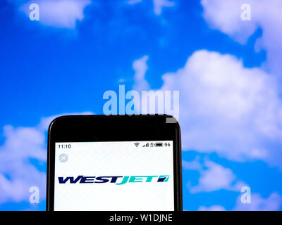 In this photo illustration a WestJet airlines logo seen displayed on a ...
