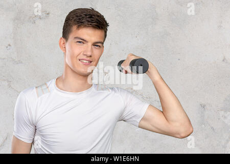 Funny weak man tries to lift a weight Stock Photo - Alamy
