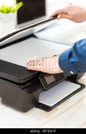Man's hand making copies. Working with printer Stock Photo - Alamy