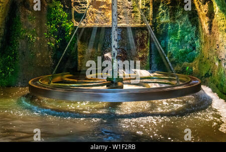 Spinning wheel of a water mill. Horizontal water wheel. Long exposure ...
