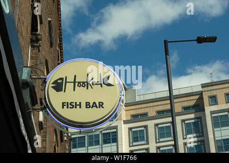 hanging sign for hooked fish bar, hammersmith, london, england, using a ...