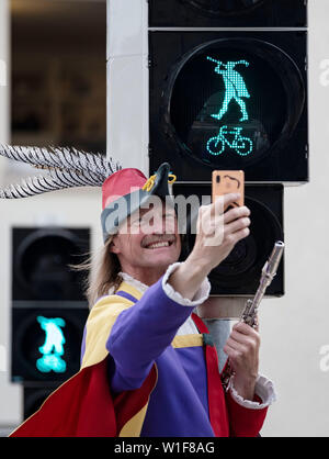 Silhouette of the rat-catcher, pied piper of Hamelin, figure against ...