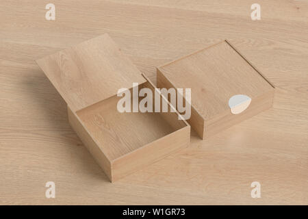 Two wooden square boxes with sliding lid on wooden background. Empty ...