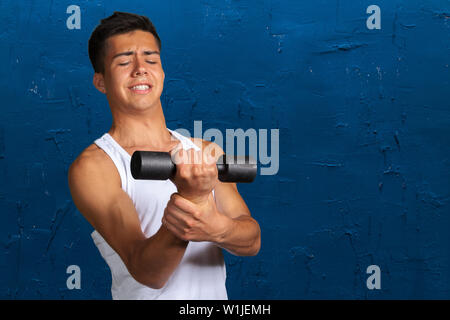 Funny weak man tries to lift a weight Stock Photo - Alamy