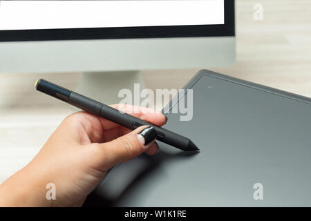 Hand of graphic designer working with stilus and tablet Stock Photo - Alamy