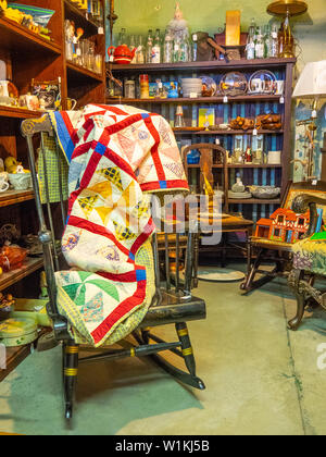 Quilts draped over chairs in Courtyard Antiques shop during Quilt Week ...