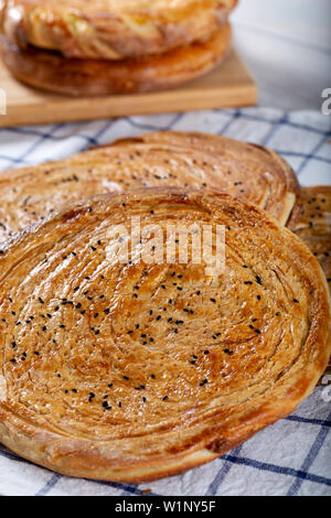 Homemade circle bread and Turkish flaky pastry (katmer Stock Photo - Alamy